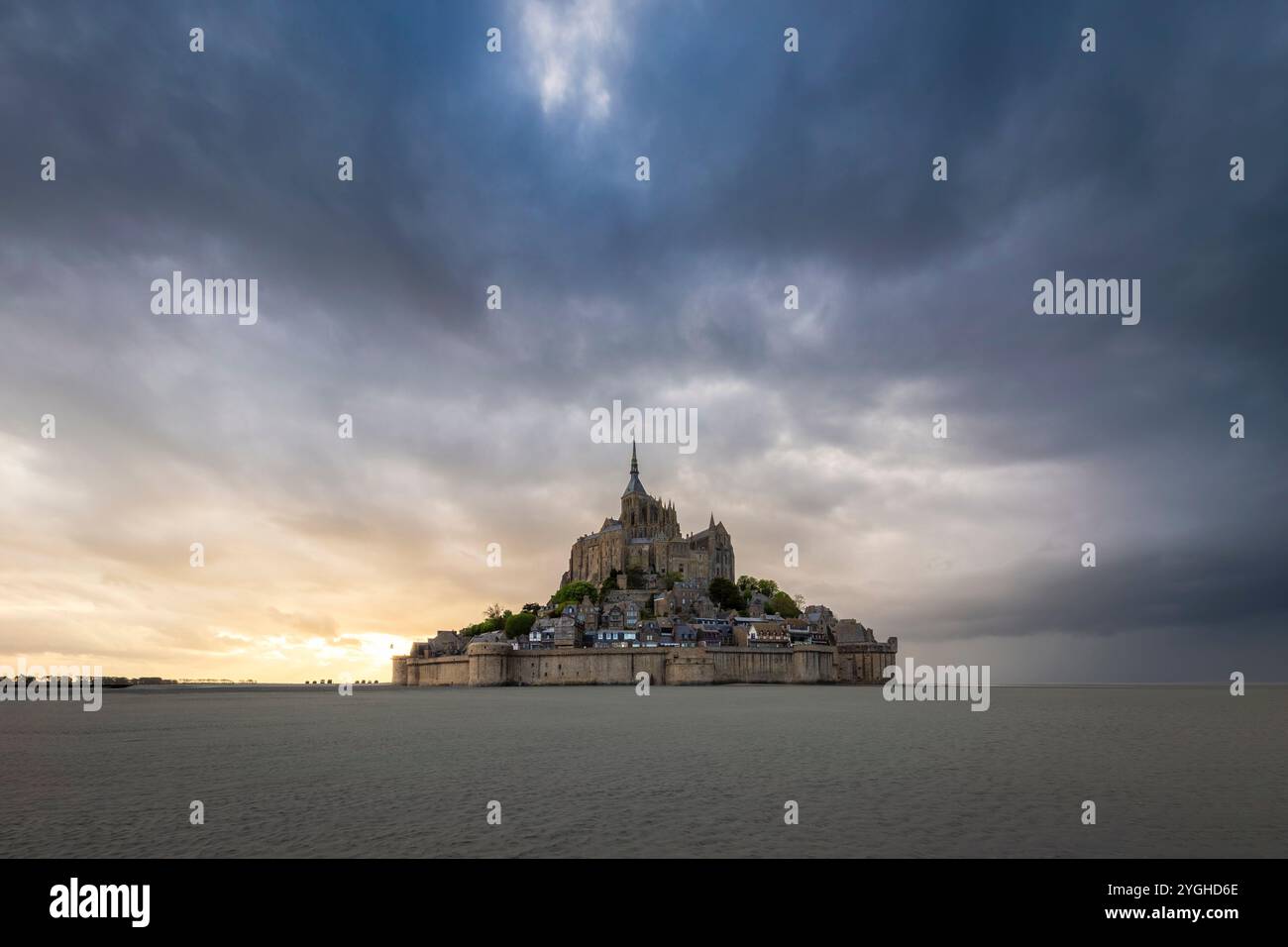 View of Le Mont Saint Michel at sunset from the beach formed at low ...