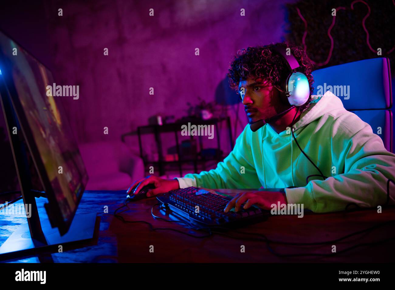 Photo of cute young guy nervous stressed play gamer computer purple ...