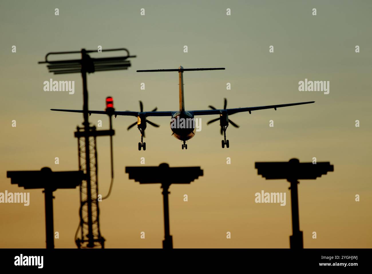 Plane landing at the airport runway with the navigation lights - sunset ...