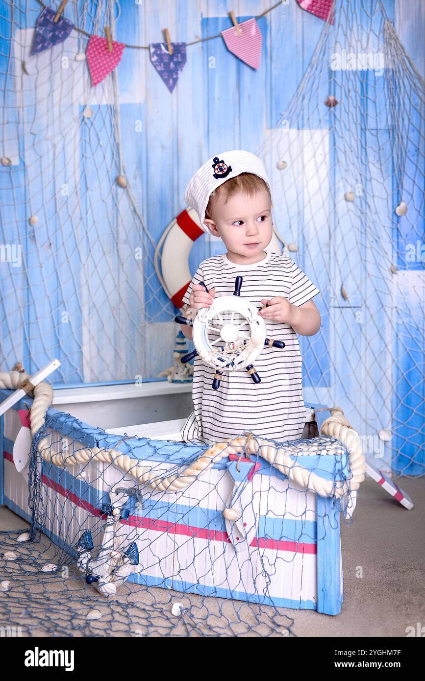 The photo shows an adorable baby in sailor clothes Stock Photo - Alamy