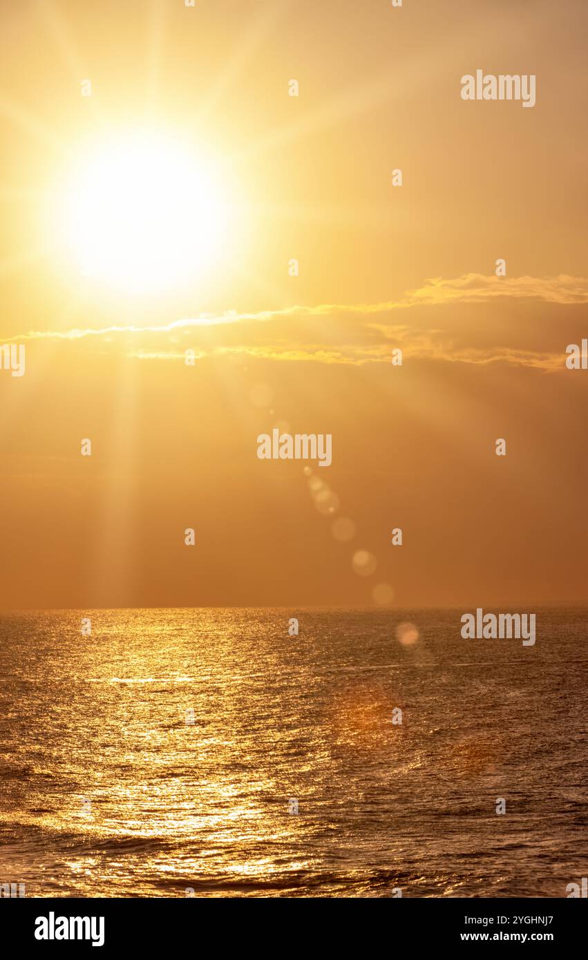 gold sunset over ocean waves, sun rays and flare , simple background ...