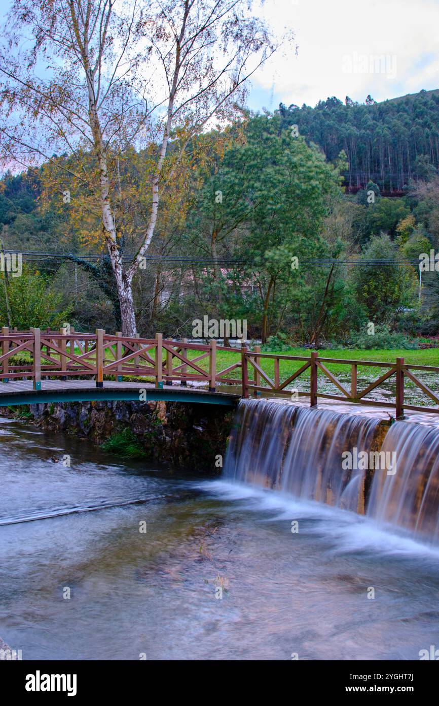 A scenic view of a small waterfall on the Saja River in Cabezon de la ...