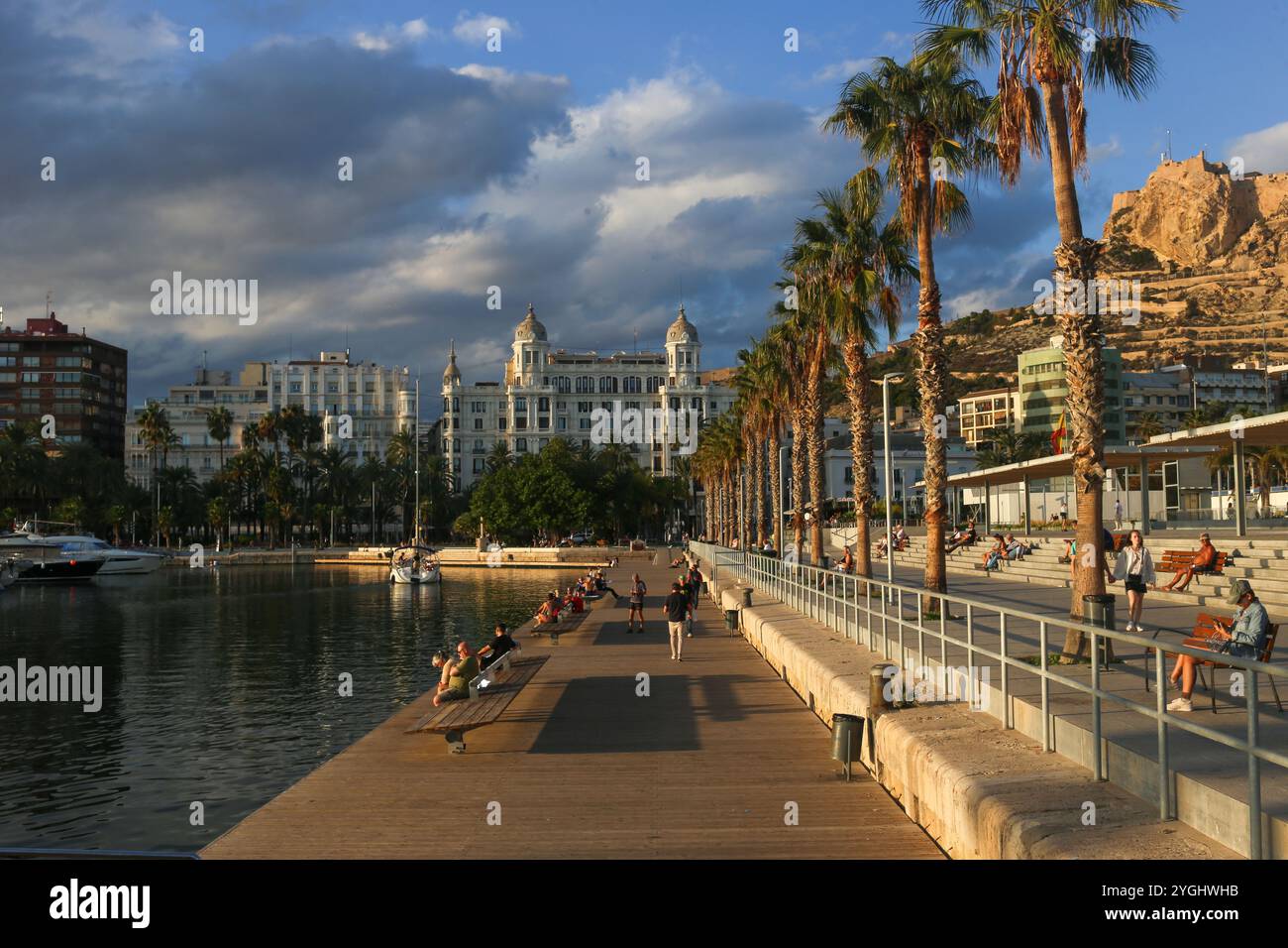 Alicante, Spain, 07th November, 2024: People sitting on benches ...