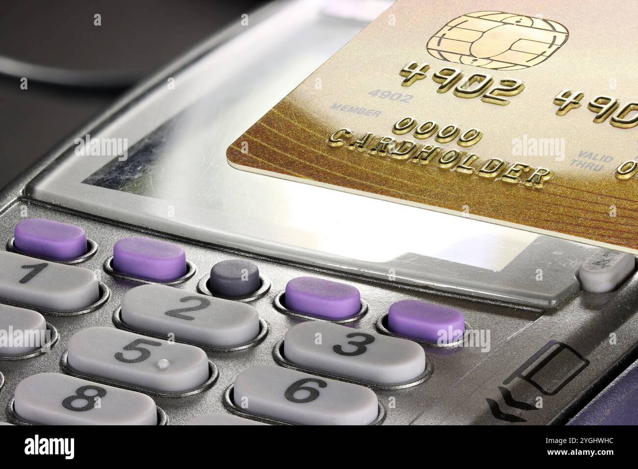 gold status bank or loyalty card held over payment terminal Stock Photo ...