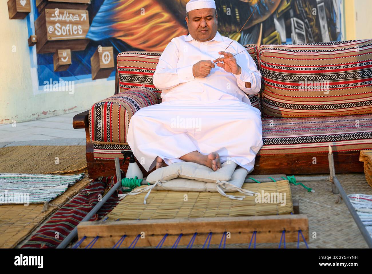 A traditional Arabic craftsman making traditional mats made from the ...