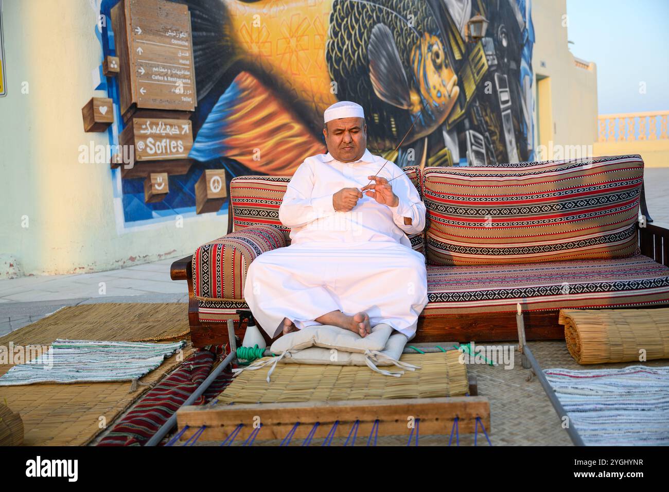 Doha Qatar; November 7th, 2024 An Arab man sits on the sofa making mats ...