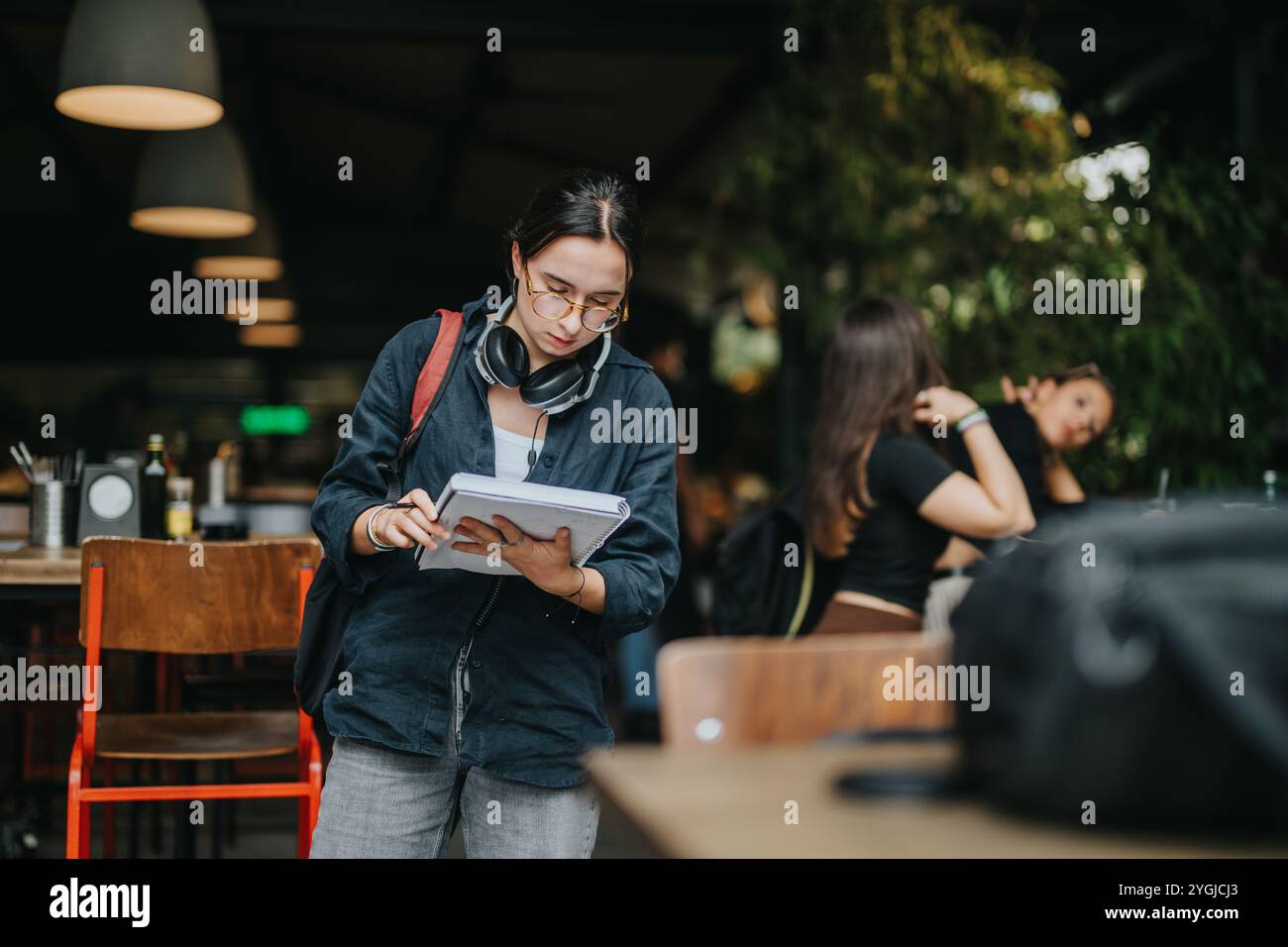 Focused high school student studying in a modern urban cafe Stock Photo ...