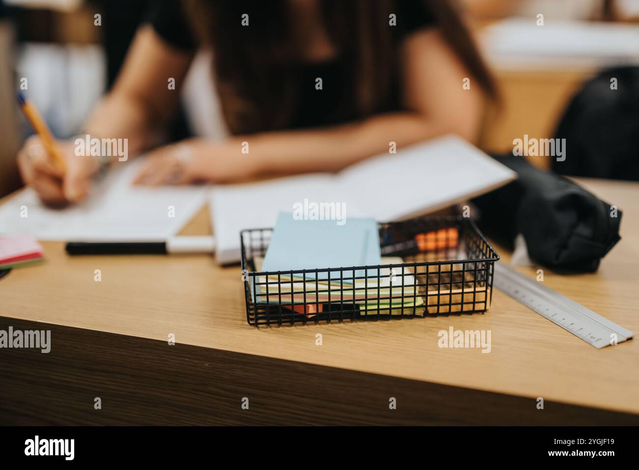 High school student writing notes during classroom session Stock Photo ...