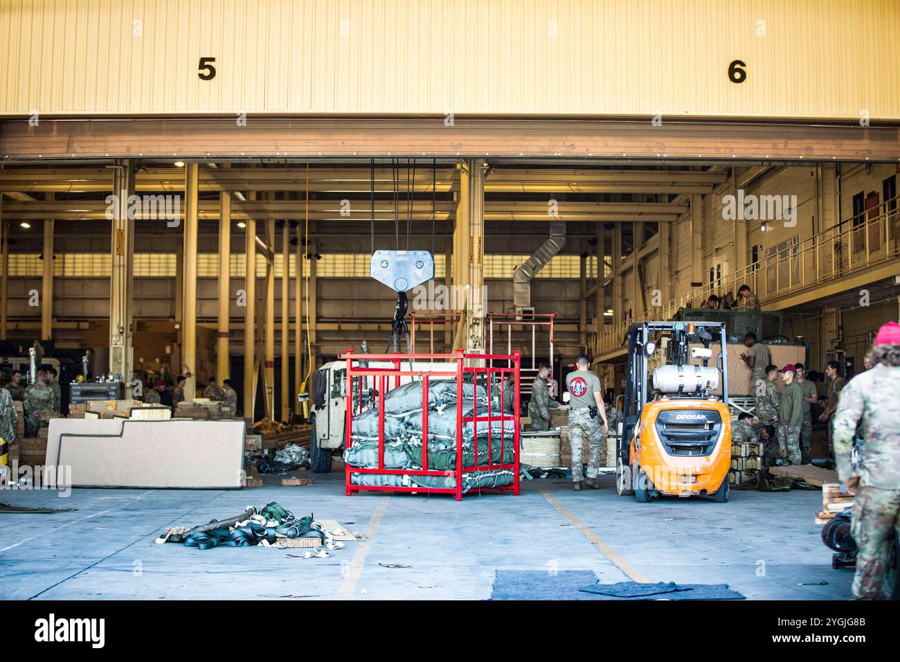 Paratroopers assigned to the 82nd Airborne Division prepare equipment ...