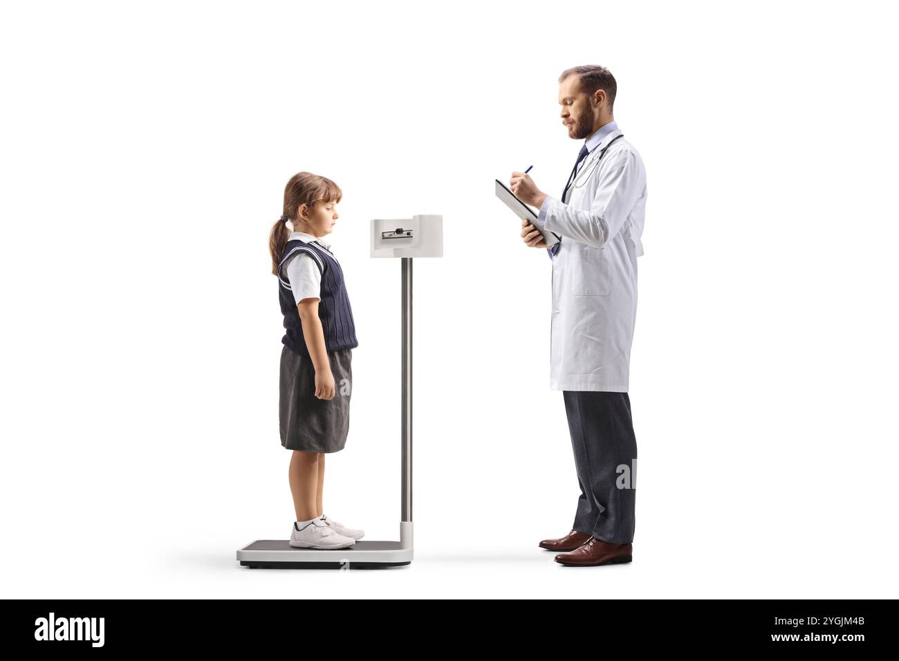Doctor measuring a child on a weight scale isolated on white background ...