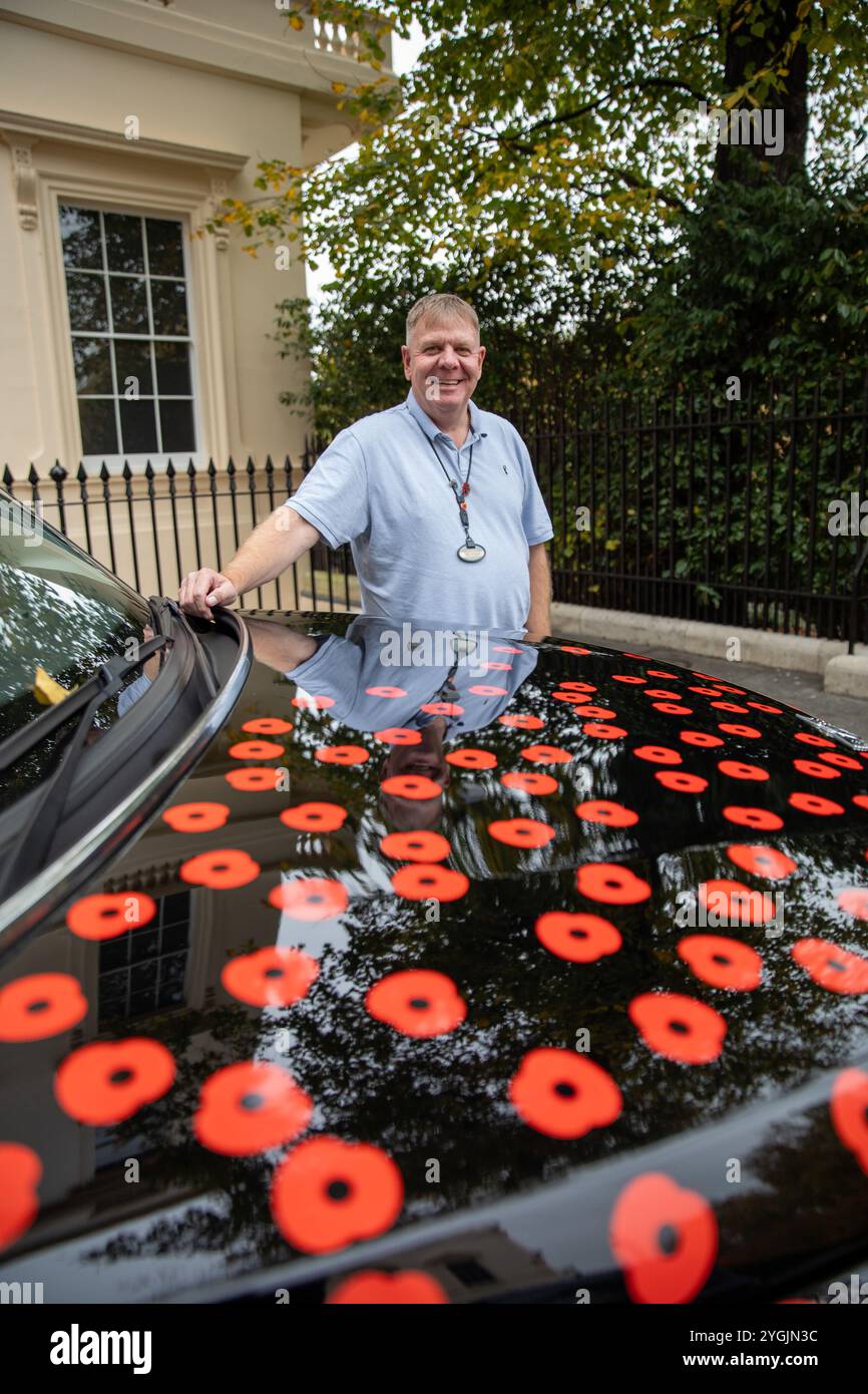 Jason, a London taxi driver stands behind his poppy decorated cab The ...