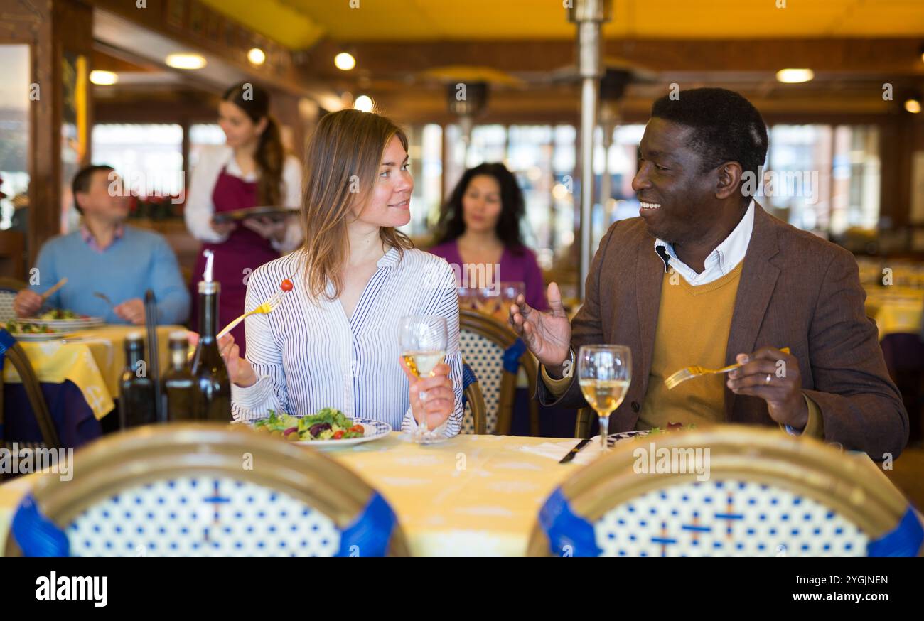 Husband and wife eating and talking in restaurant Stock Photo - Alamy