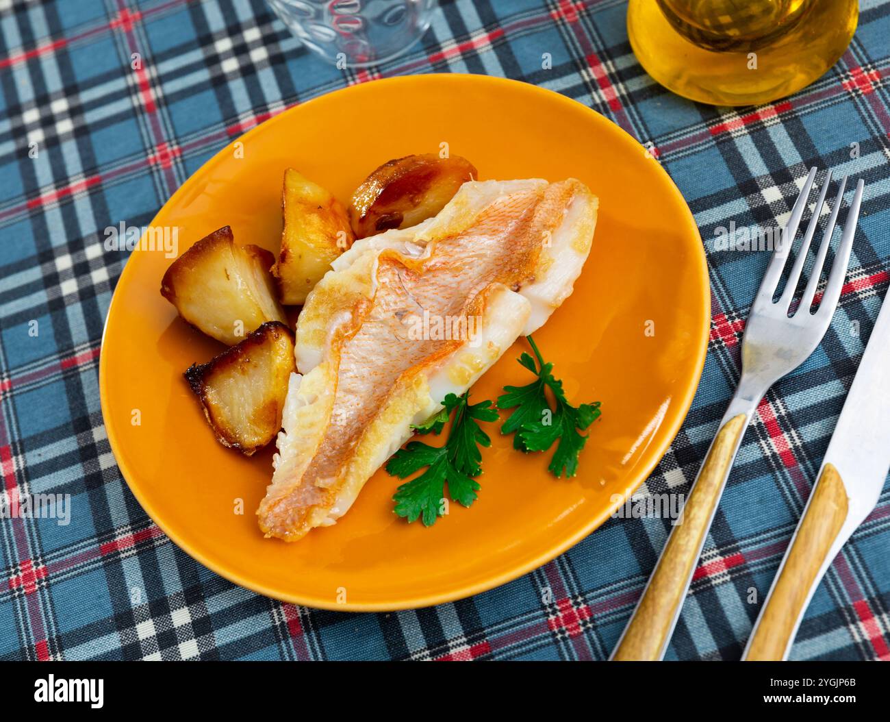 On plate, slice of fried redfish garnished with French fries Stock ...