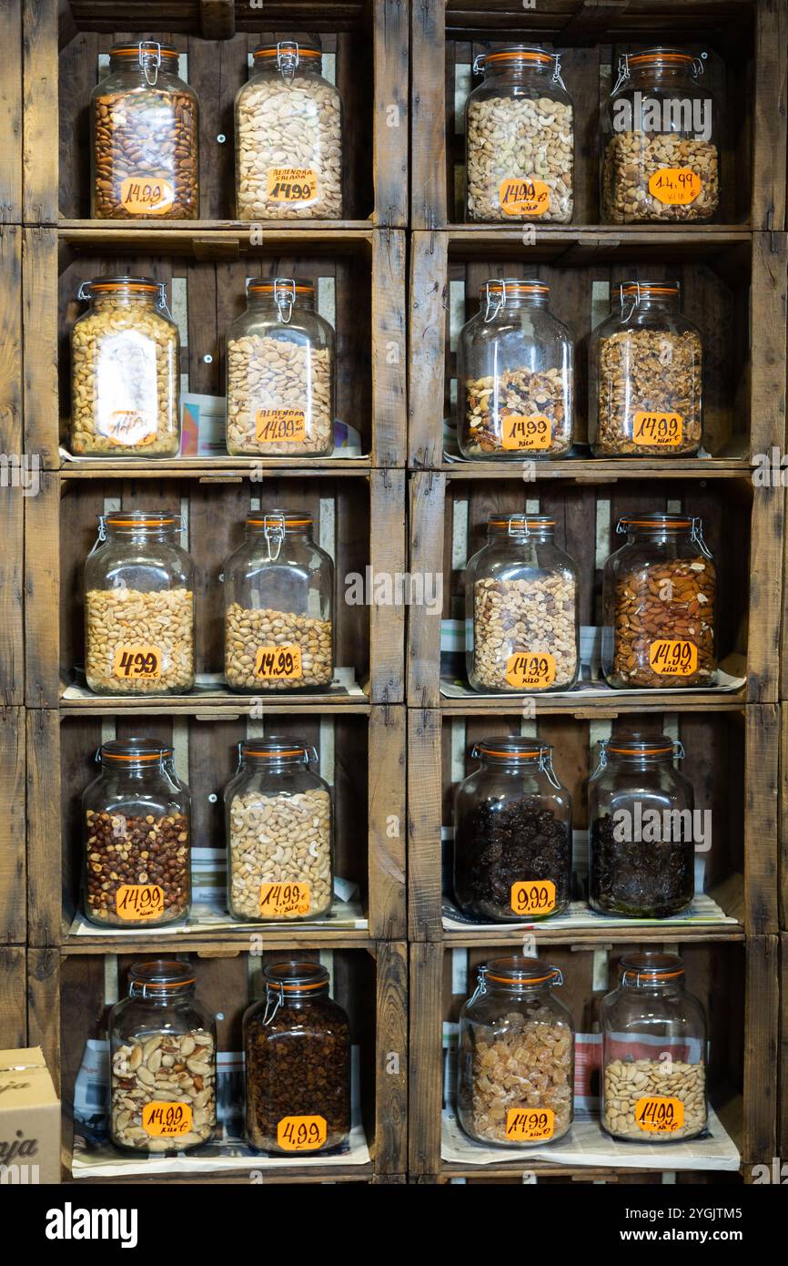 Nuts in jars on display for sale on market shelves Stock Photo - Alamy