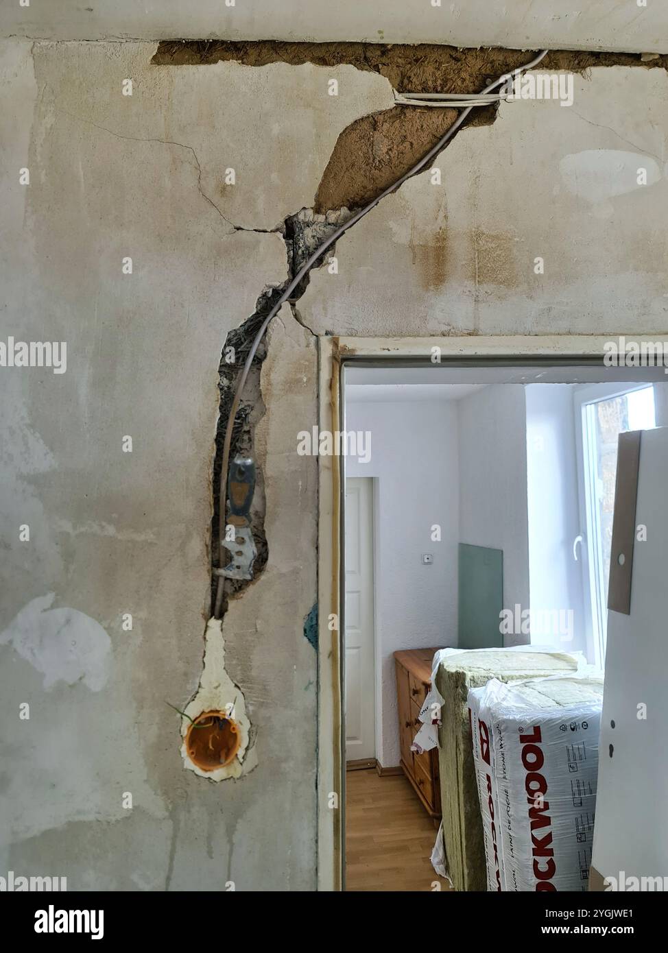 a wall was prised open to lay new power cables Stock Photo - Alamy