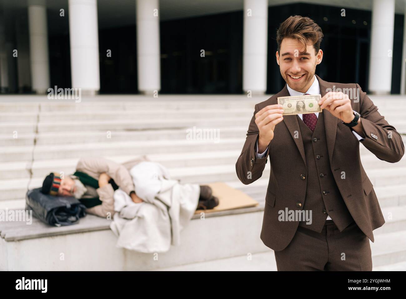 Joyful successful businessman in suit cheerful looking at camera as ...