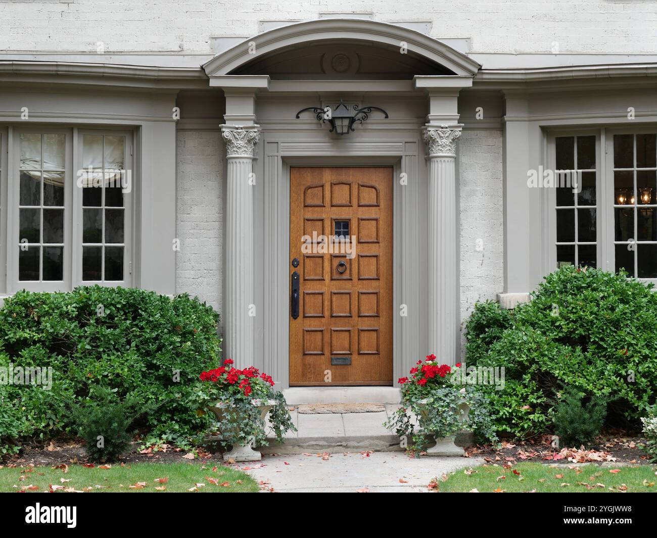 House with elegant wood grain front door and columns Stock Photo - Alamy