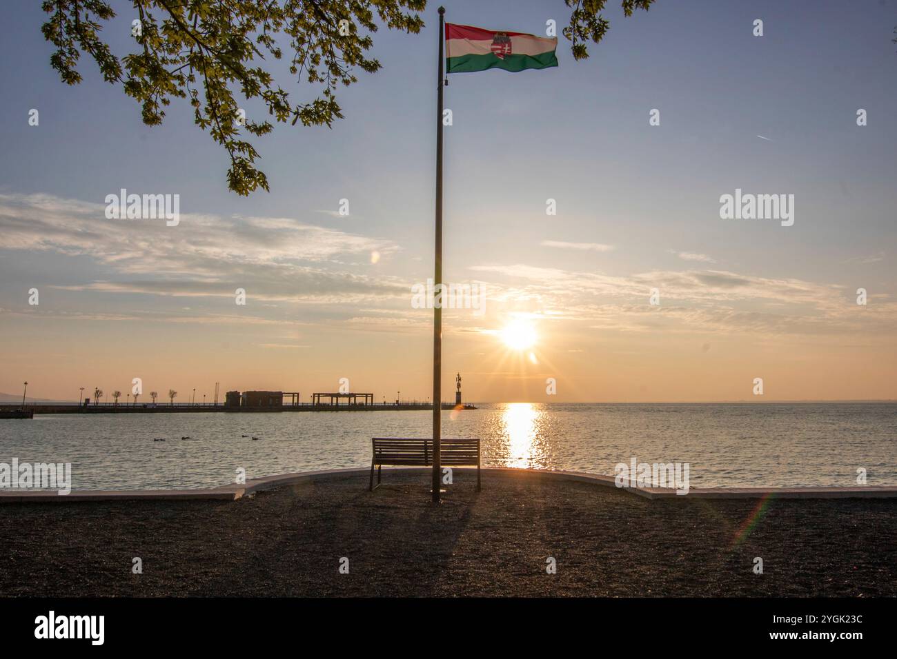 Sunrise on the shore and harbor of a lake in summer. Colorful sky with ...
