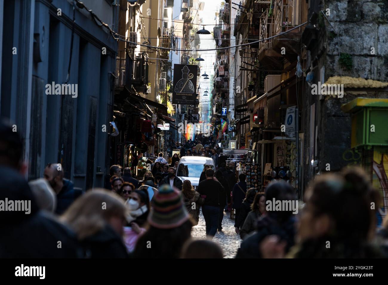 Narrow street and colorful old buildings with crowd of people old ...