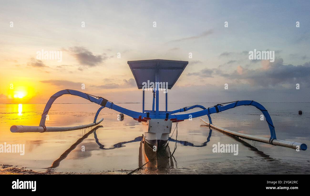 Fantastic sunrise on the beach with small temples and a traditional ...