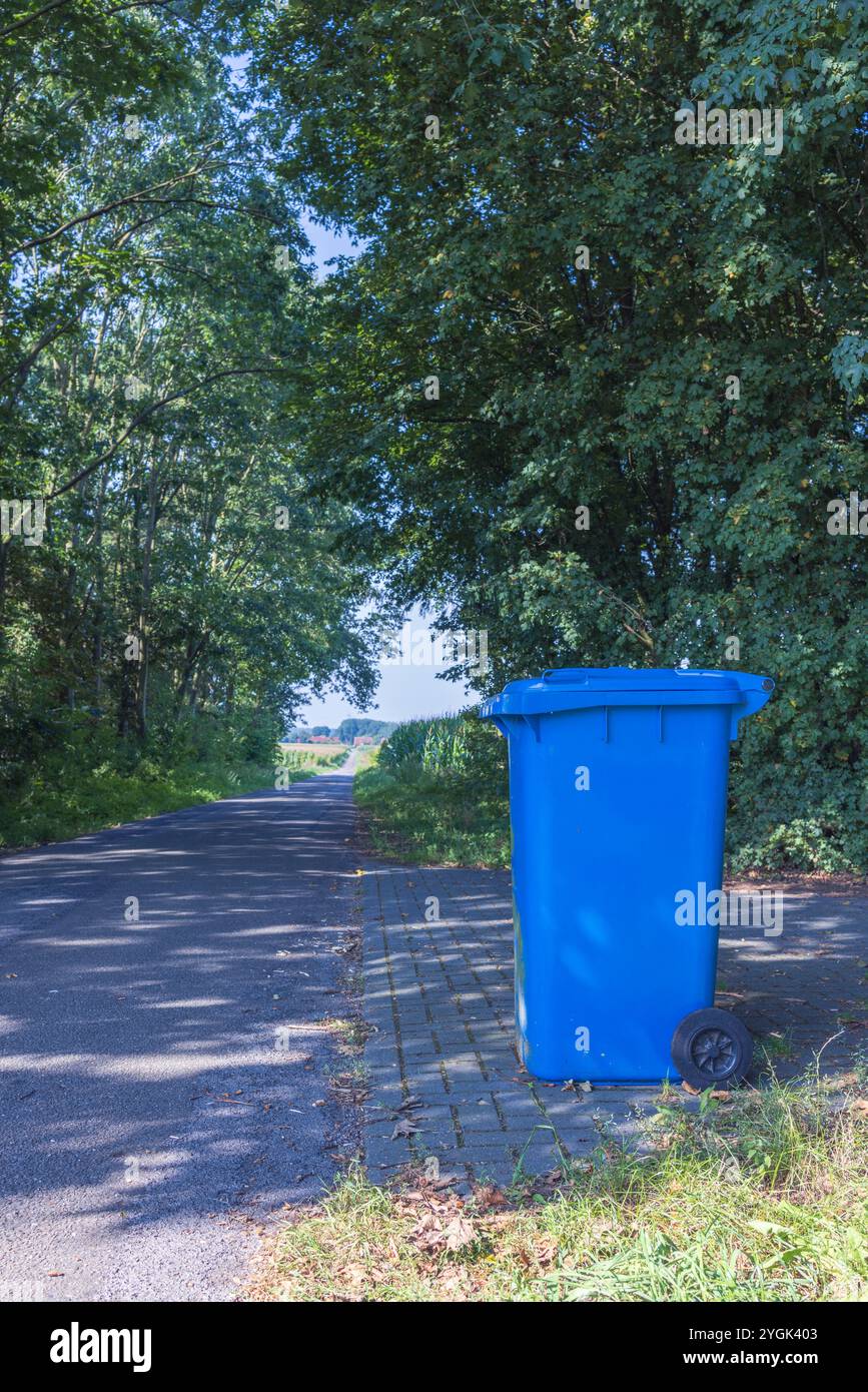 Waste cardboard, blue garbage can for paper waste, recyclable, rural ...