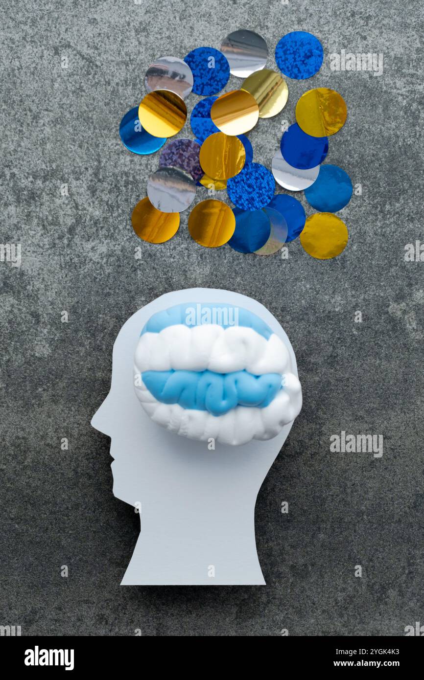 Silhouette of a human head with blue brain on a concrete background ...