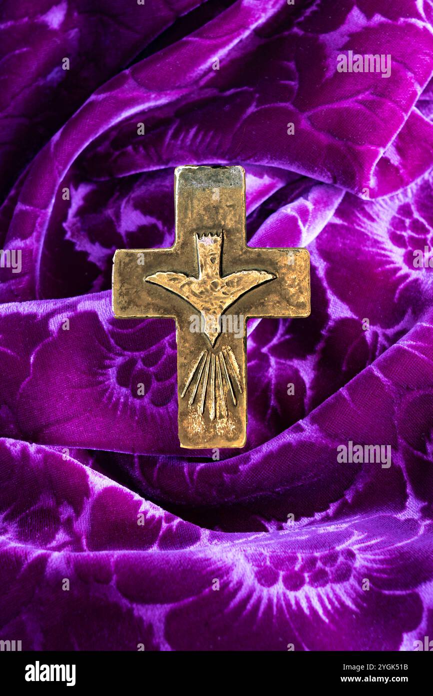 Gold cross with Holy Spirit has purple background of embossed silk ...