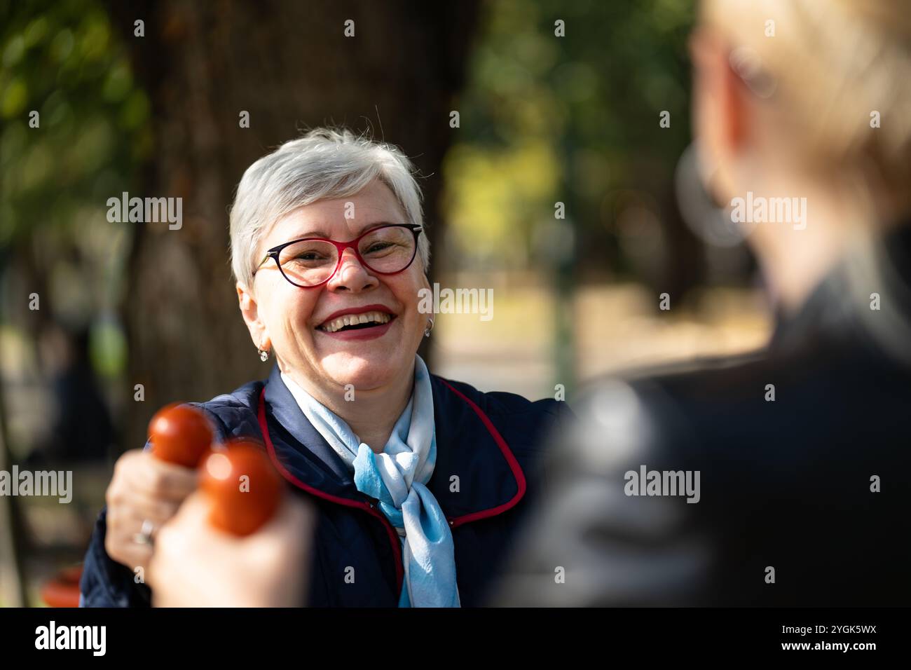 A senior woman and her daughter working out together. The mother in ...