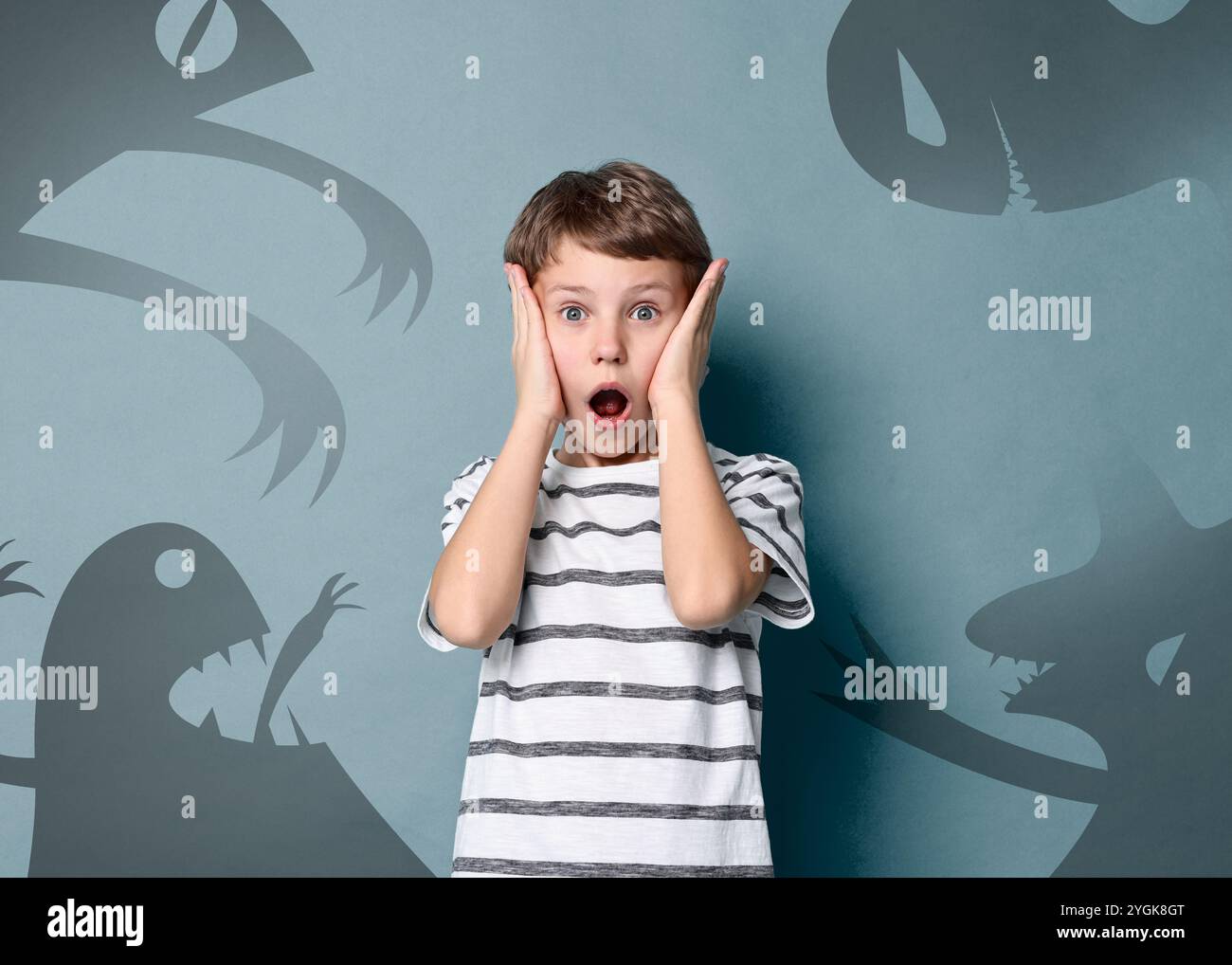 Boy scared of monsters, teraphobia. Creepy shadows behind him Stock ...