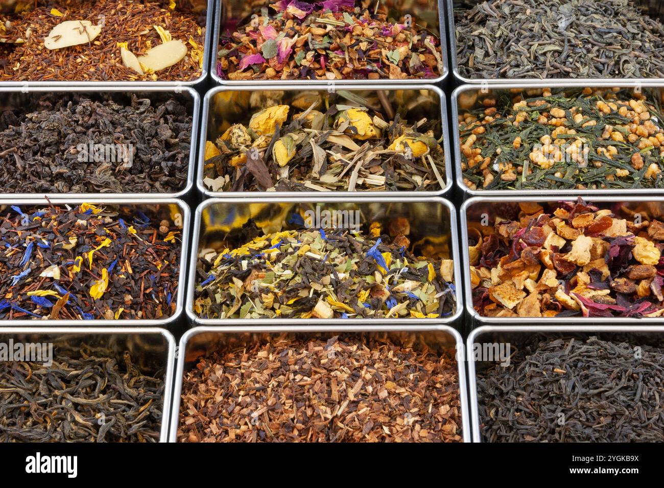 A vibrant assortment of loose-leaf teas in metal tins, featuring green ...