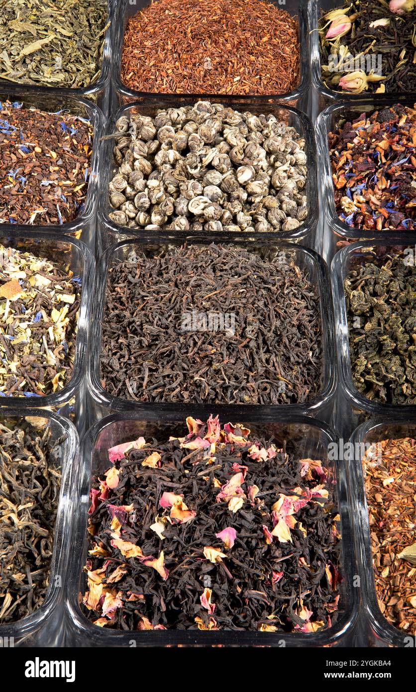 A vibrant assortment of loose-leaf teas in glass jars, featuring green ...