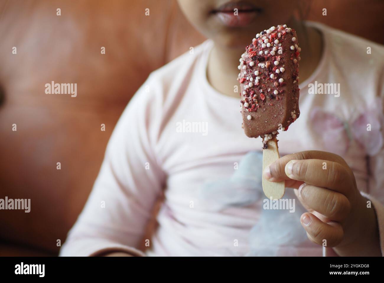 child happily eating an ice cream bar, exuding joy and enjoyment Stock ...