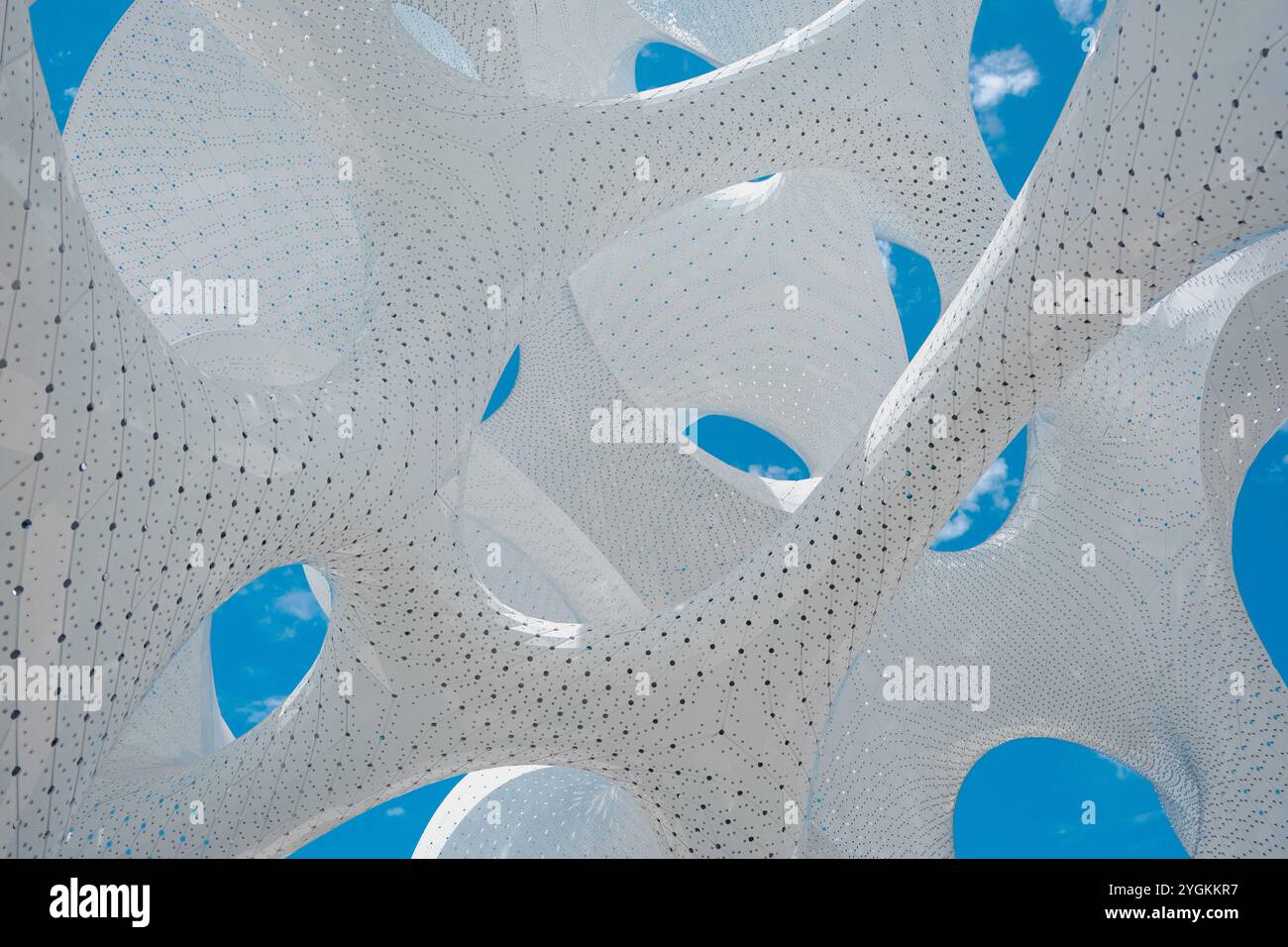 A dynamic white structure appears as an optical illusion against a blue ...
