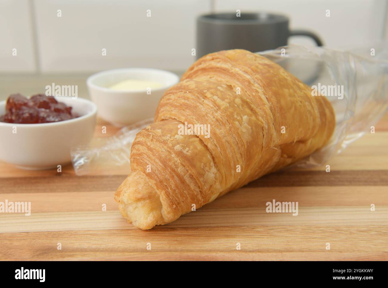 Convenience breakfast food concept, croissant in plastic packaging with ...