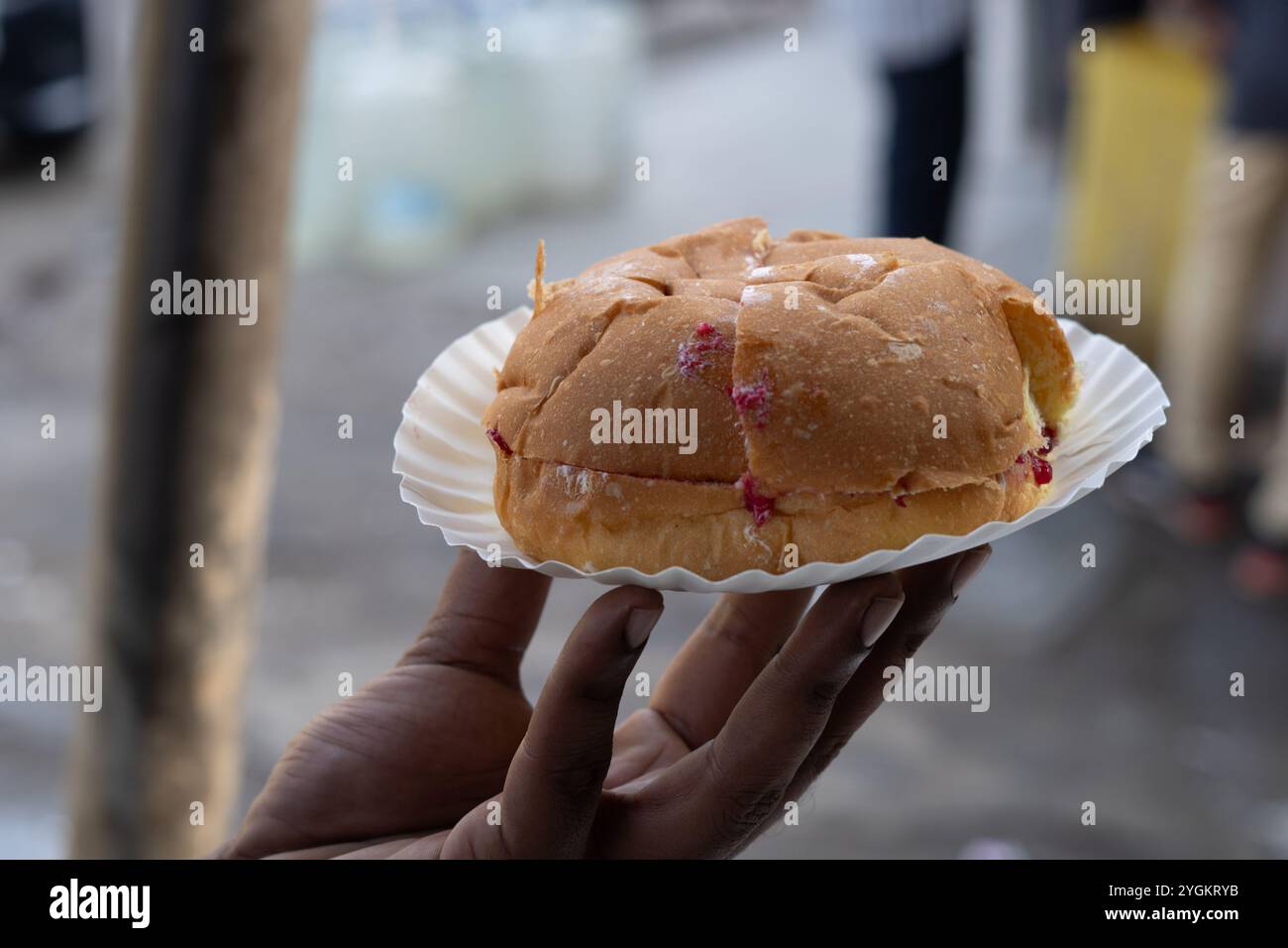 South indian man holding bun butter jam Stock Photo - Alamy