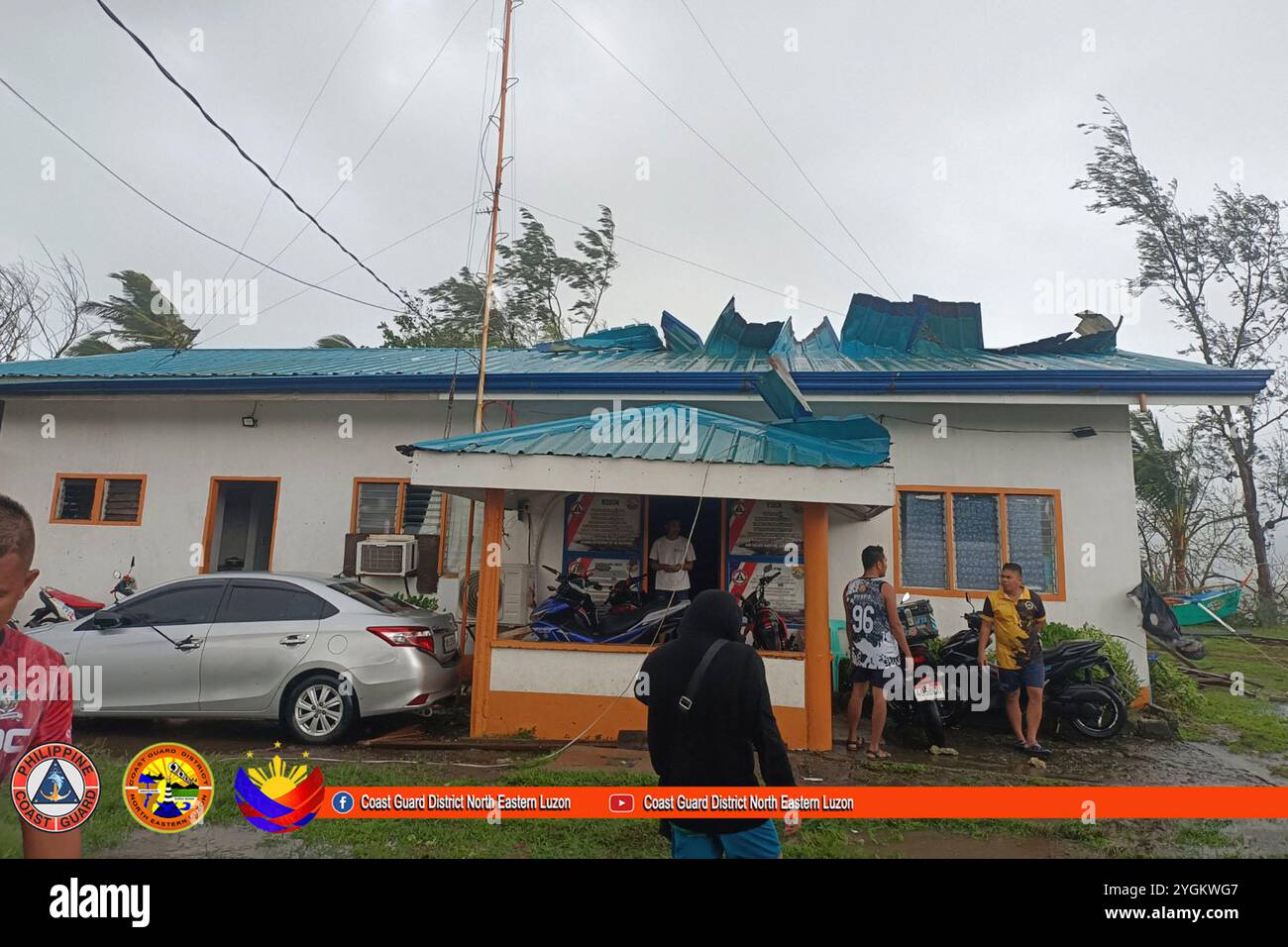 In this photo provided by Philippine Coast Guard, its members stand ...