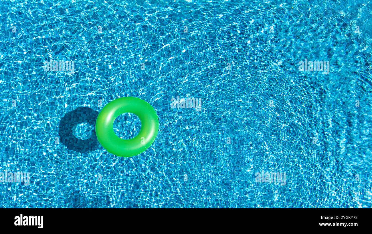 Aerial view of colorful inflatable ring donut toy in swimming pool ...