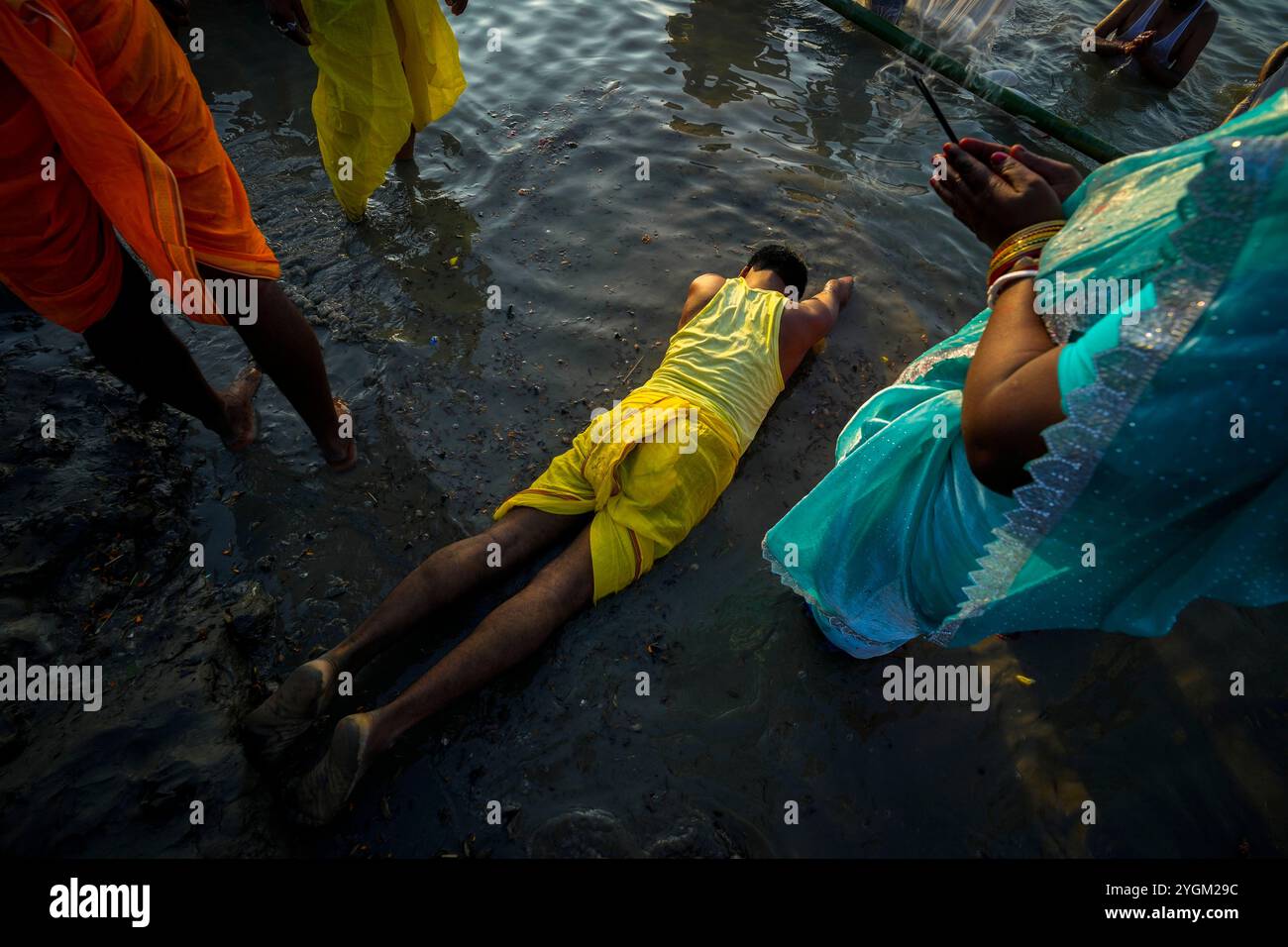 A Hindu devotee prostrates to the river Brahmaputra during Chhath ...