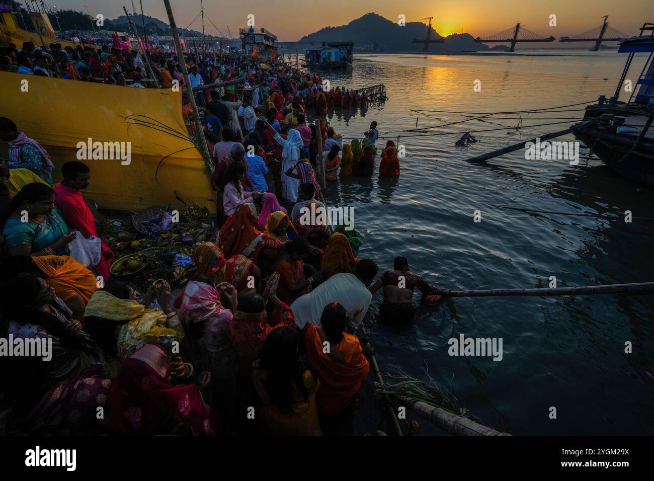 Hindu devotees gather by the river Brahmaputra and offer prayers during ...