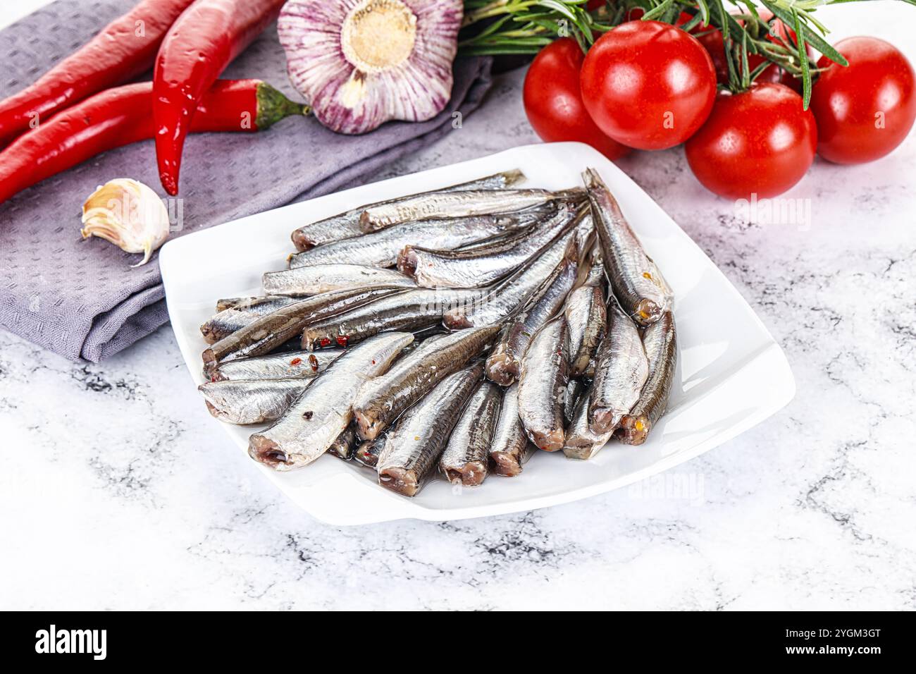 Pickled anchovy fish in the plate Stock Photo - Alamy