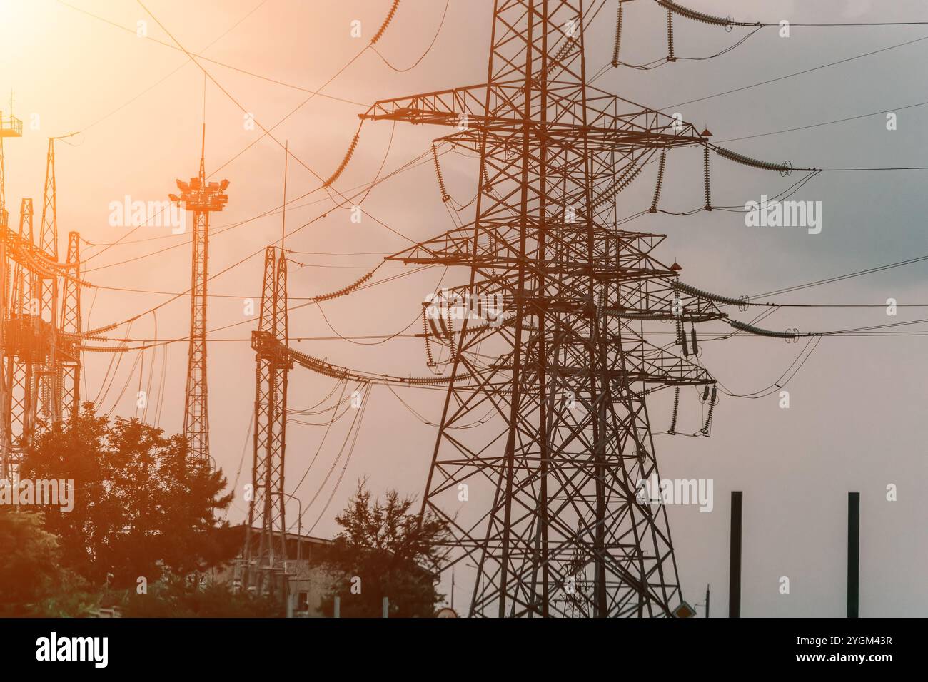 High voltage electric distribution network at sunset. Power ...