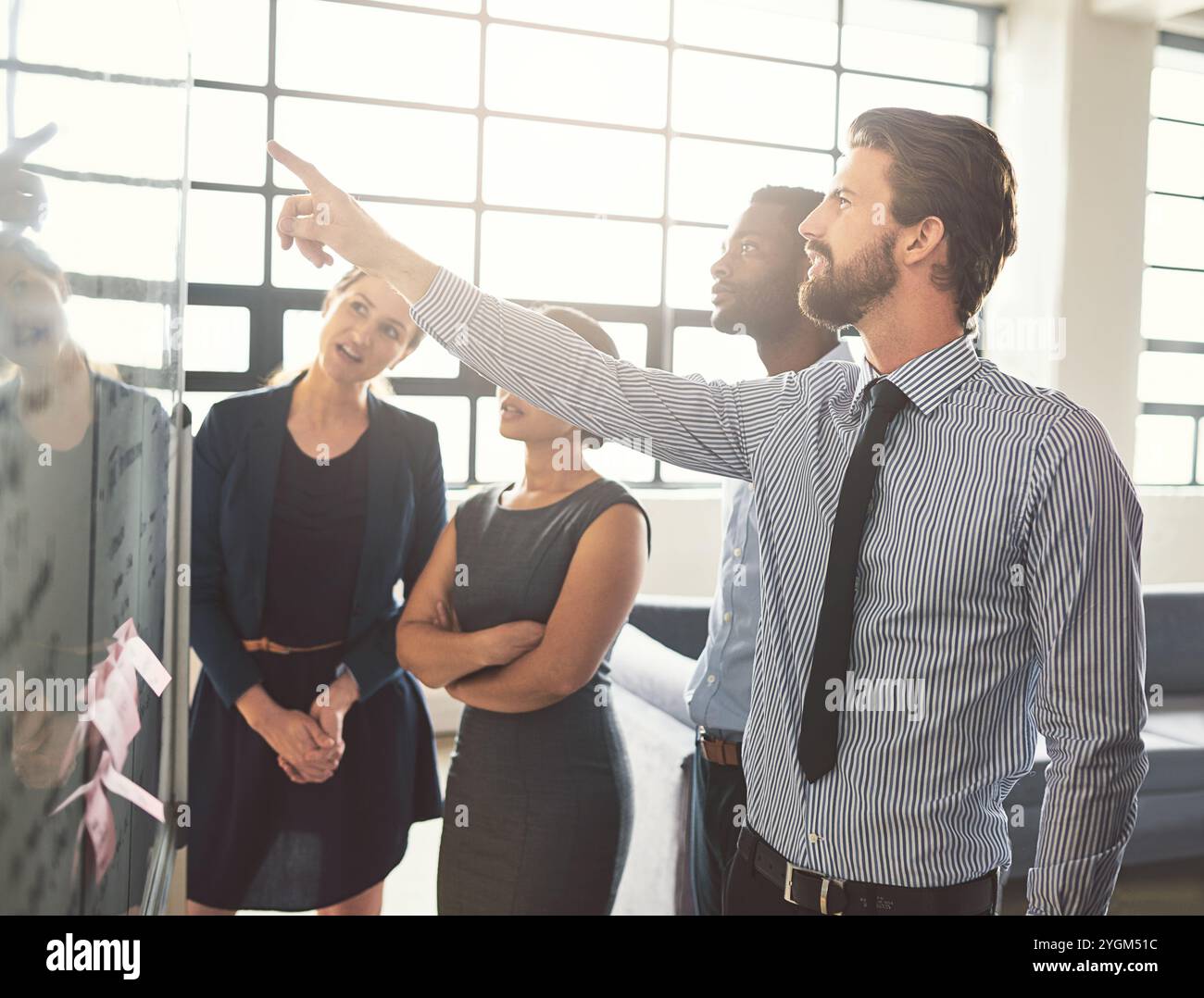 People, meeting and pointing to whiteboard in office of schedule ...
