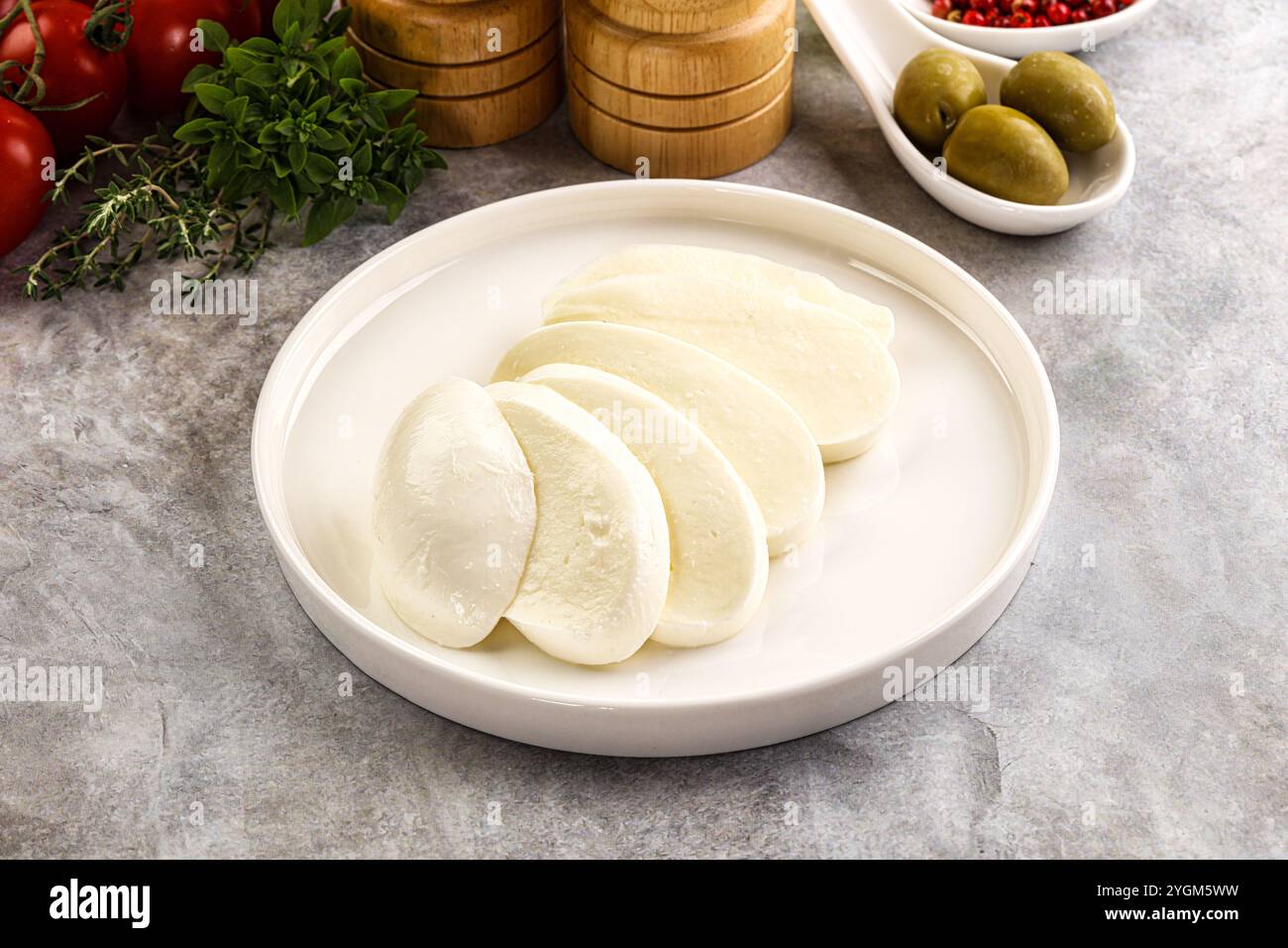 Organic mozzarella cheese slices in the plate appetizer Stock Photo - Alamy