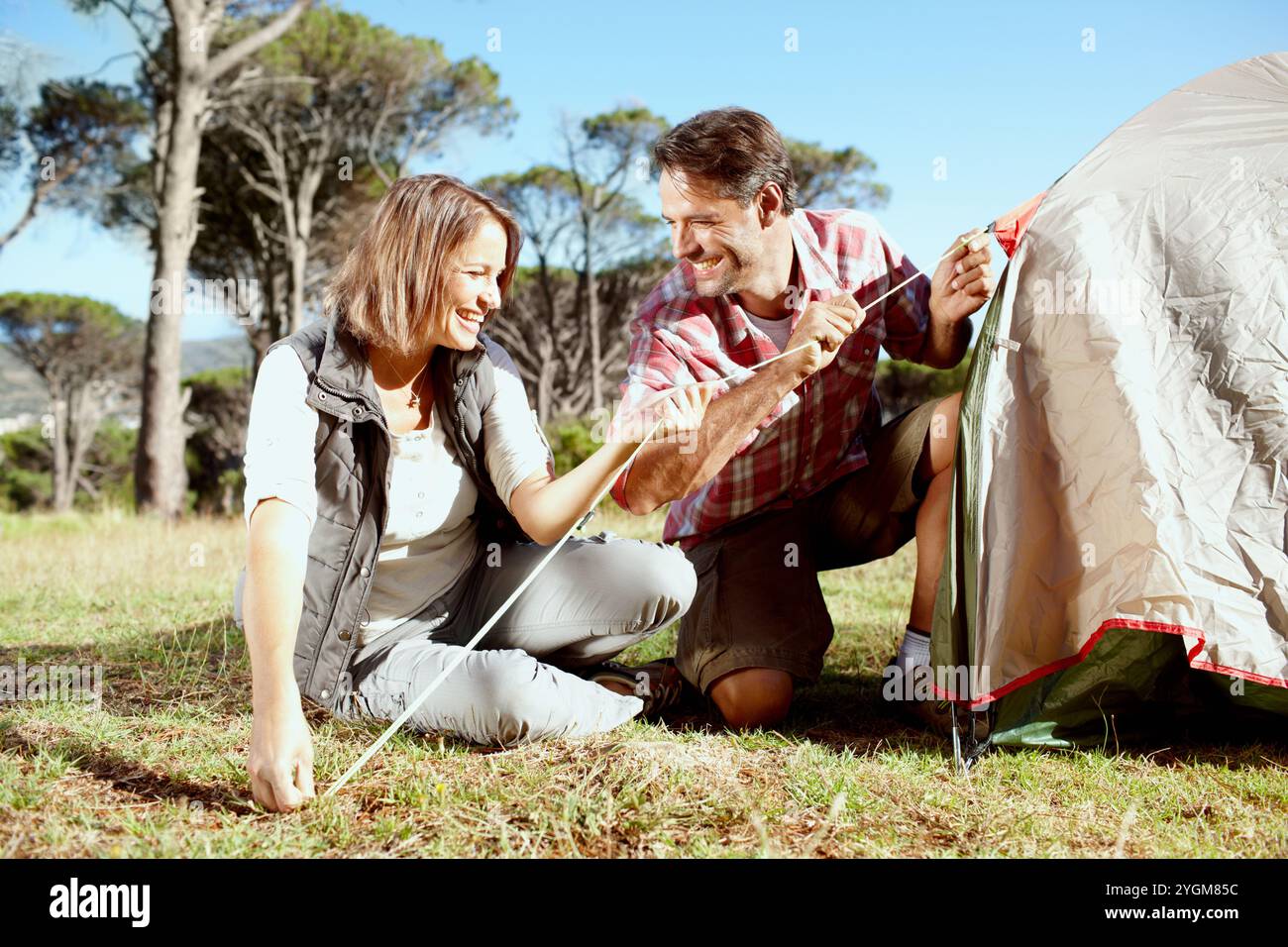Outdoor, couple and pitch tent for camping in holiday adventure ...