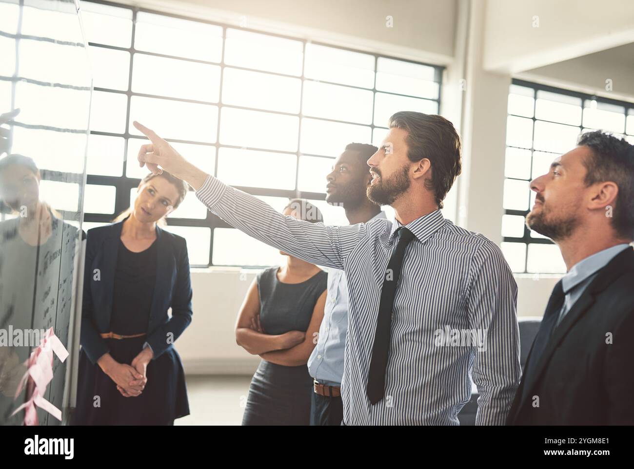 People, presentation and pointing to whiteboard in office of schedule ...