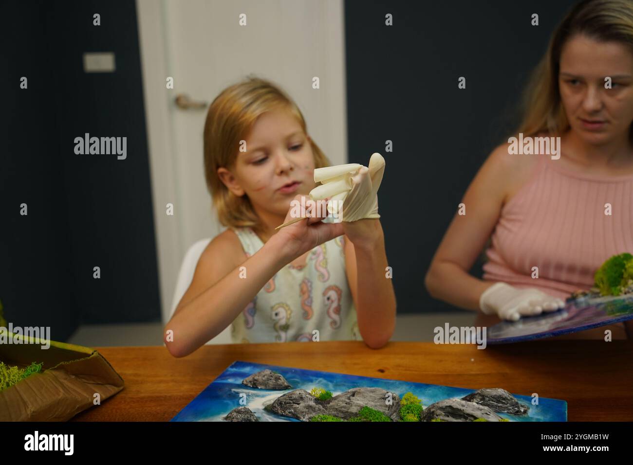 A mother and her daughter craft vibrant natural landscapes Stock Photo ...