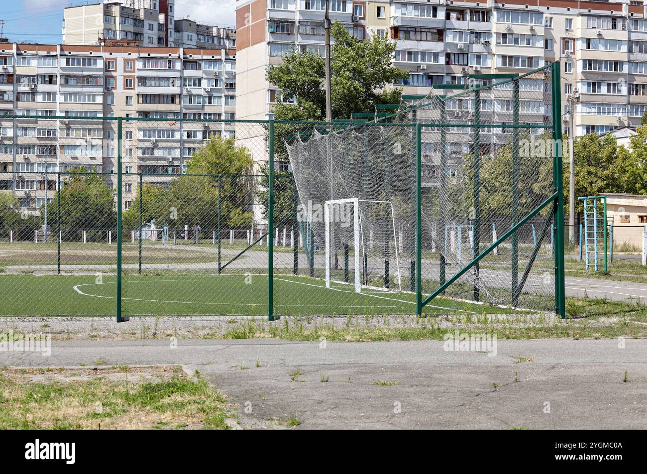 Lawn field for playing football behind the green fence mesh at school ...