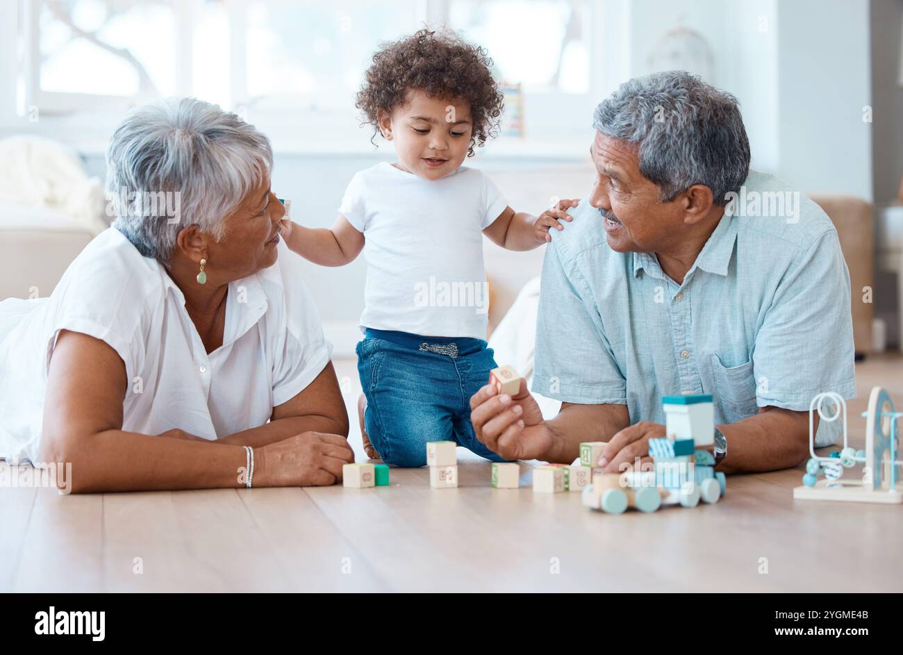 Toys, bonding and baby with grandparents in home for learning ...