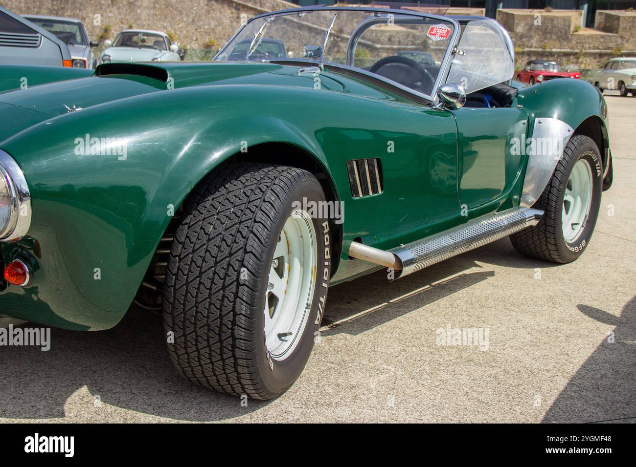 Classic green ac cobra roadster parked, showcasing its powerful front ...