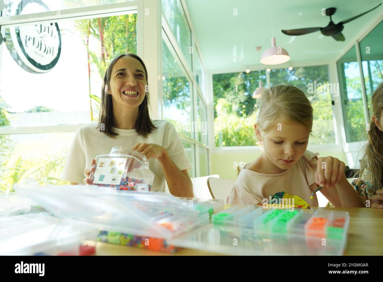 Teacher in workshop teched two girls how to assemble a thermo mosaic ...